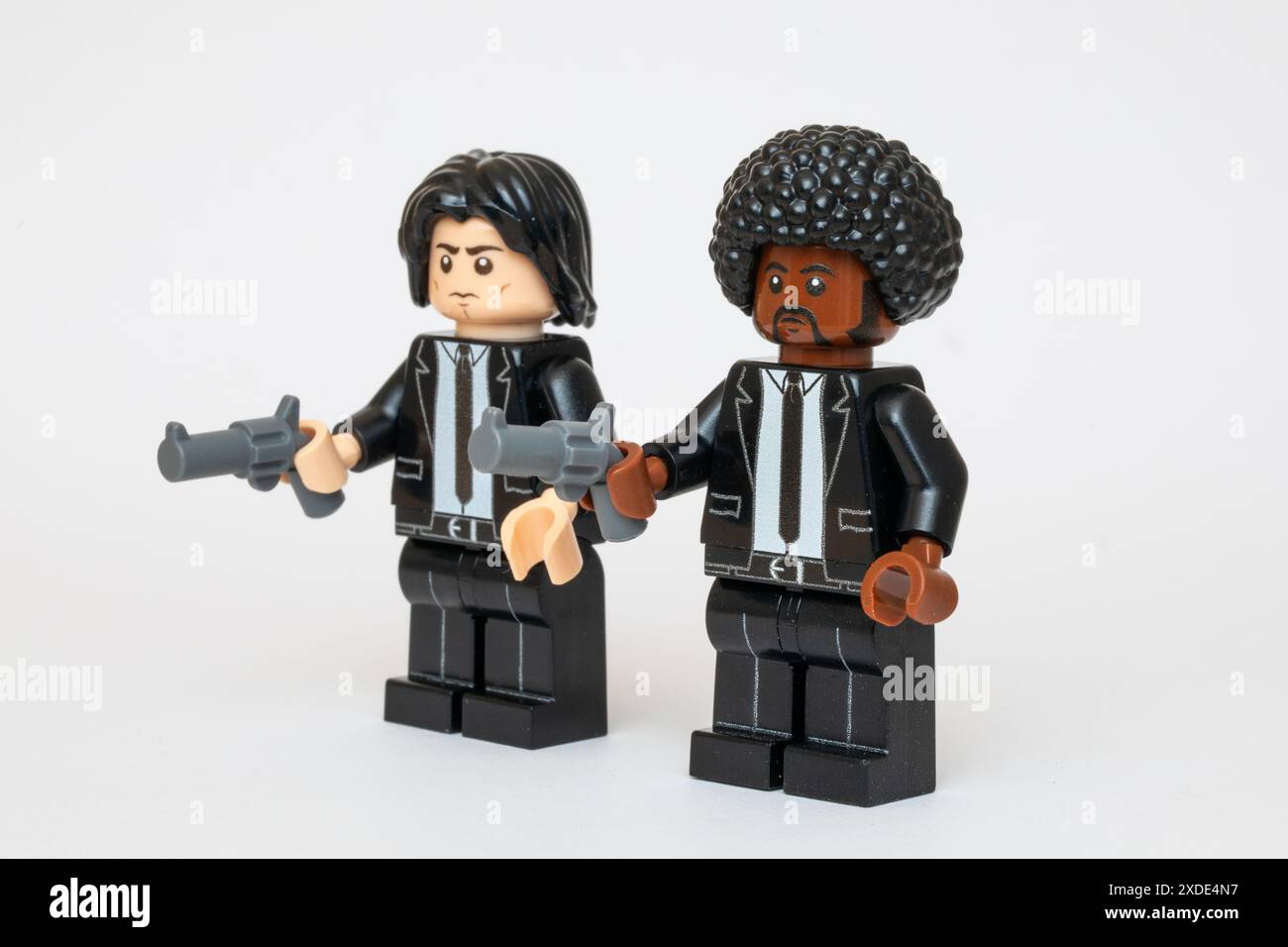 Two Lego minifigures dressed in a black suit holding a weapon Stock ...
