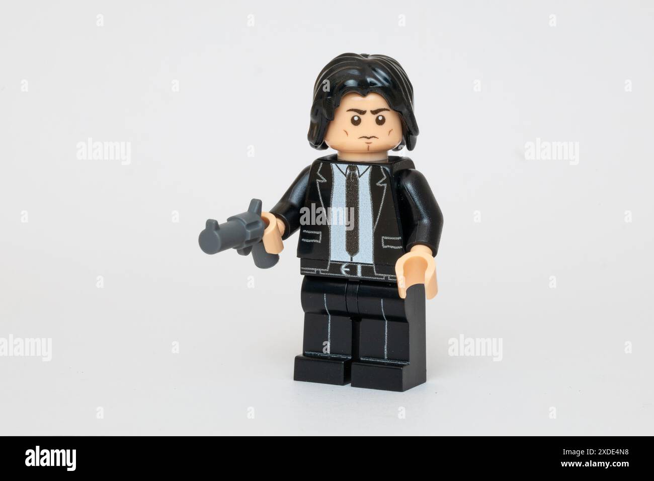 A Lego minifigure dressed in a black suit holding a weapon Stock Photo ...