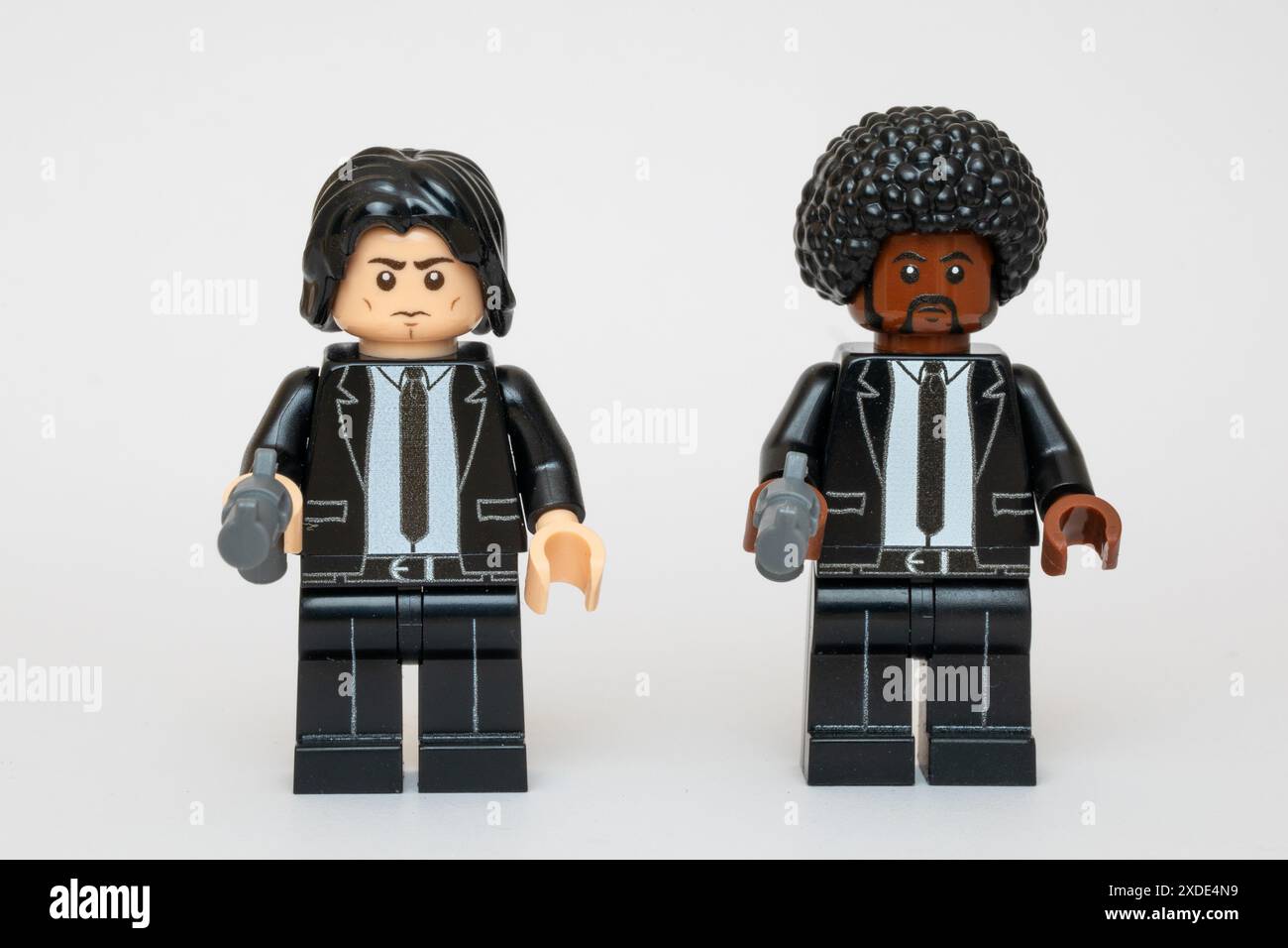 Two Lego minifigures dressed in a black suit holding a weapon Stock ...