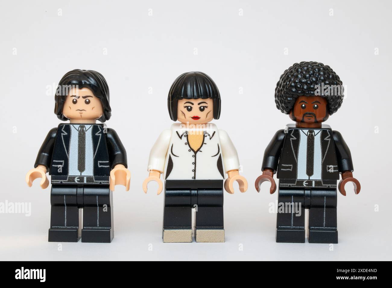 Three Lego minifigures dressed in black suits and white shirts standing ...