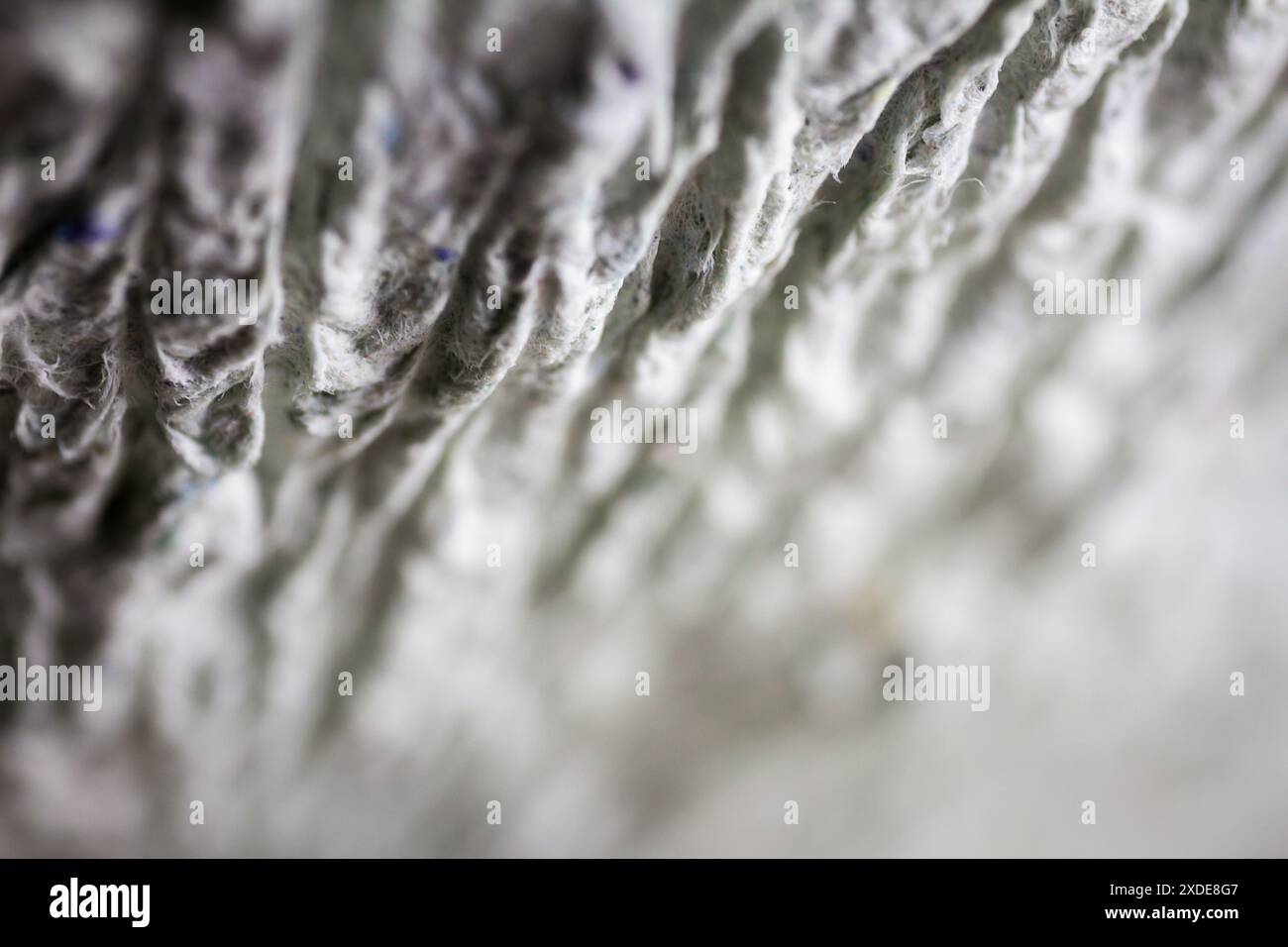 Extreme close up of old gray handmade paper mache with a structure and ...
