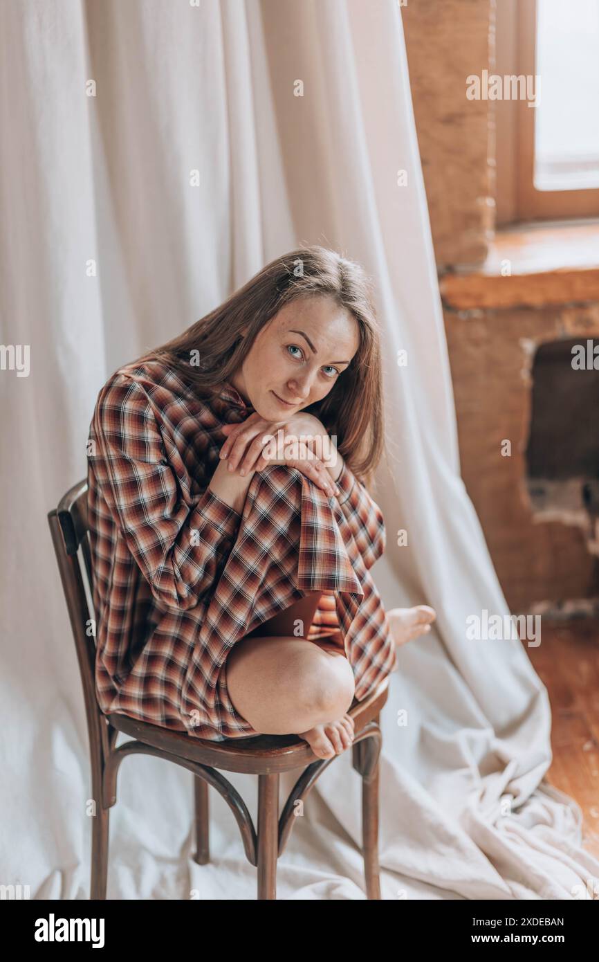 Amidst a rustic setting, a woman finds a moment of calm, her soft ...