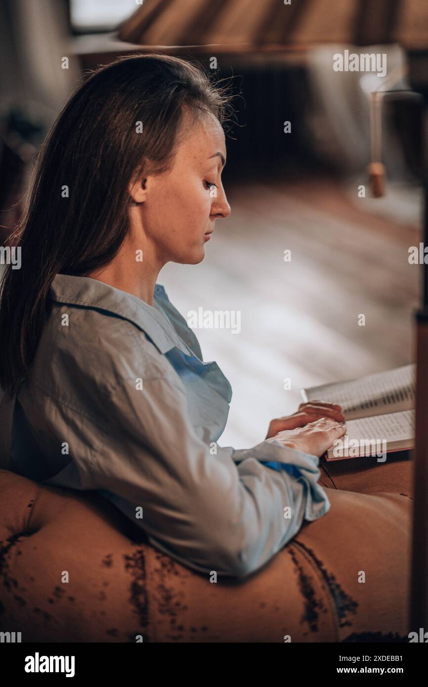 peaceful moment of a woman enjoying a good read Stock Photo - Alamy