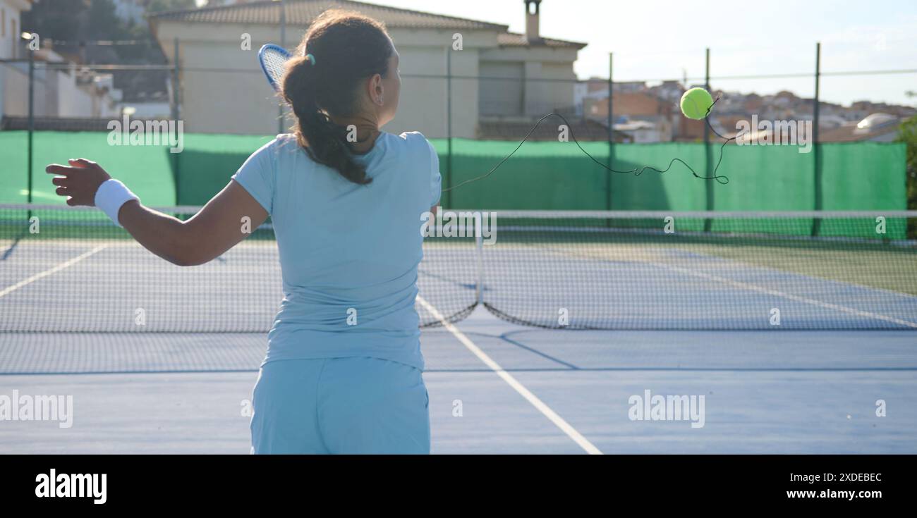 Mid adult woman hitting tennis ball hi-res stock photography and images ...