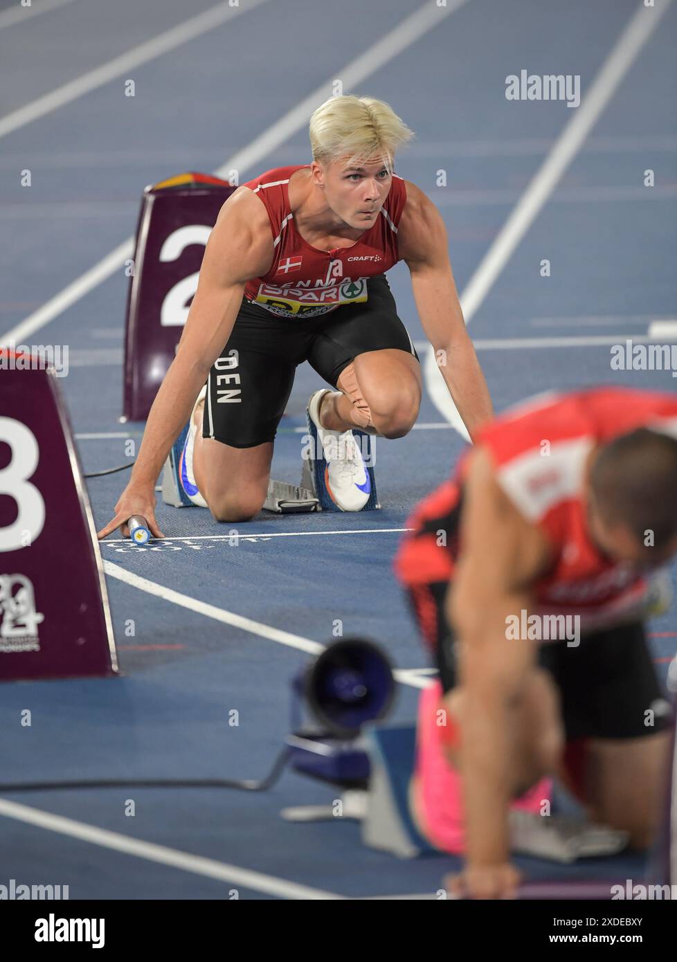 Simon Hansen of Denmark runs the first leg for his team in the men’s ...