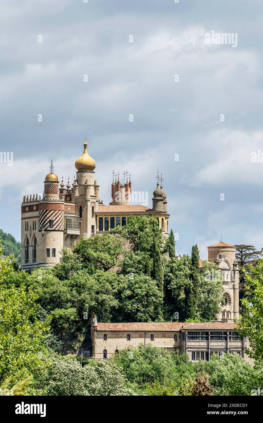 Vertical view of the ancient Rocchetta Mattei surrounded by greenery ...