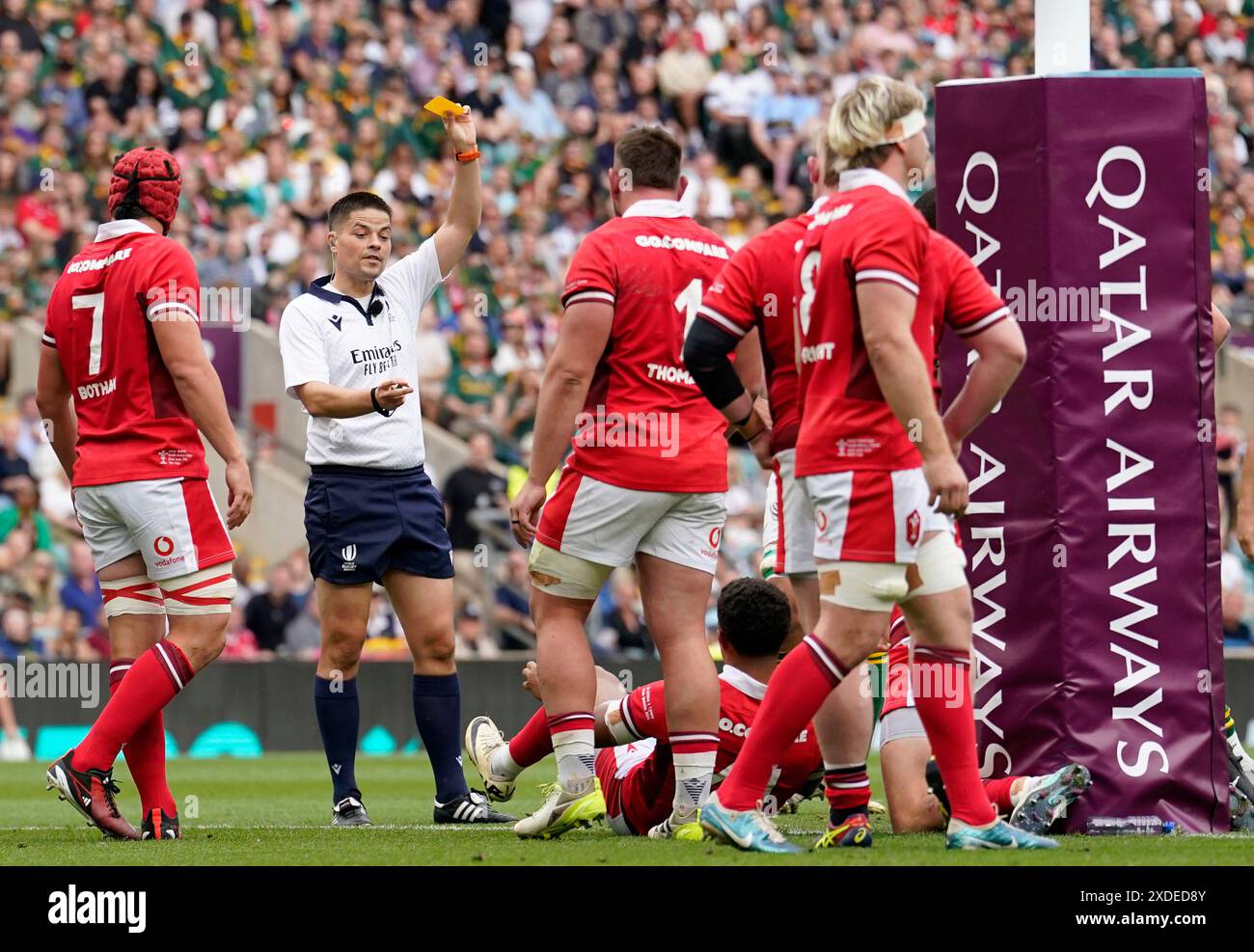 Referee Chris Busby shows a yellow card to Wales' Rio Dyer (sat on the ...