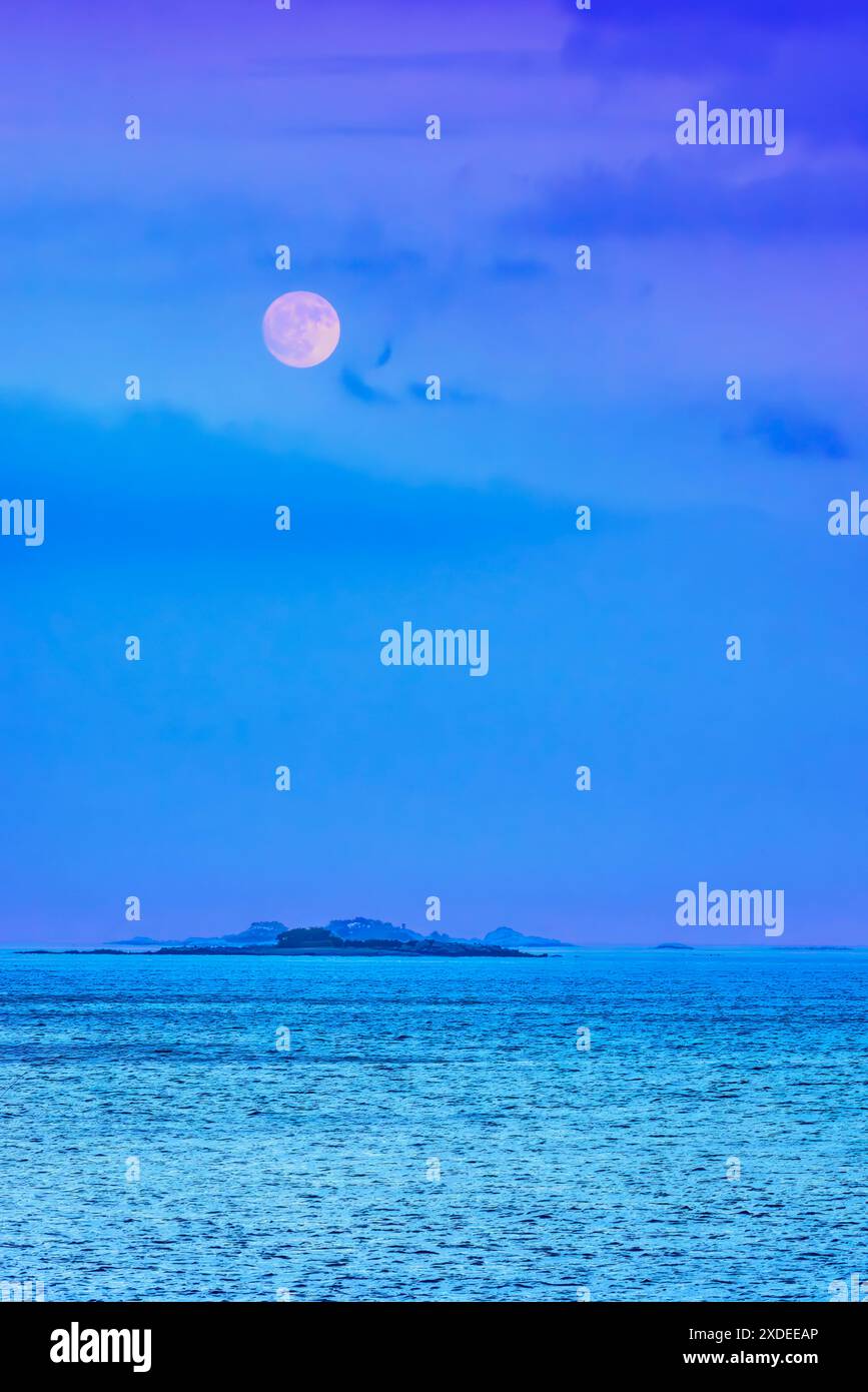 Strawberry Moon Rising Over a Small Island as the Impending Summer ...