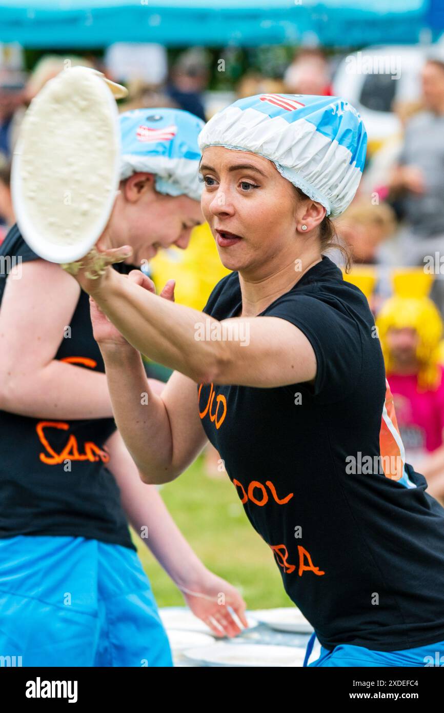 Close up of a young woman throwing a custard pie during a custard pie ...