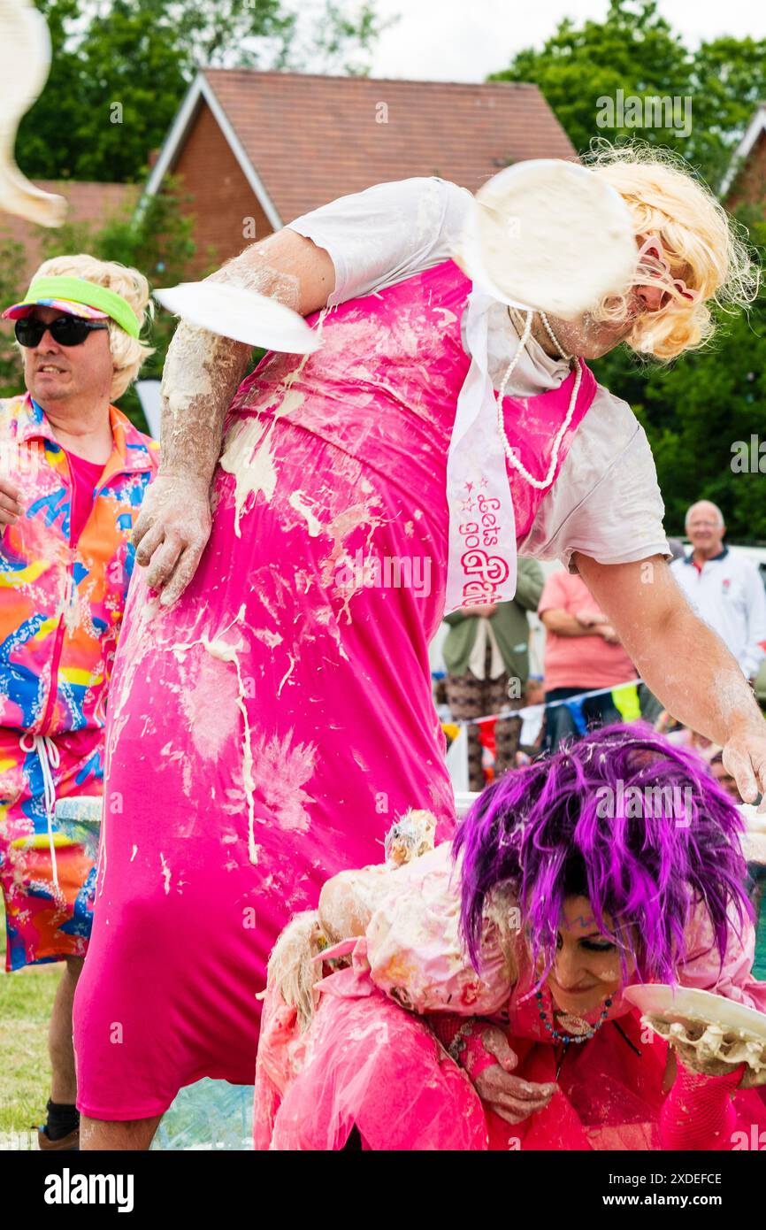 Man dressed in pink barbie doll dress getting hit in the face by a ...