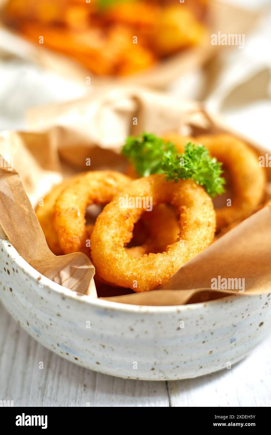 Fried breaded onion rings on white background Stock Photo - Alamy