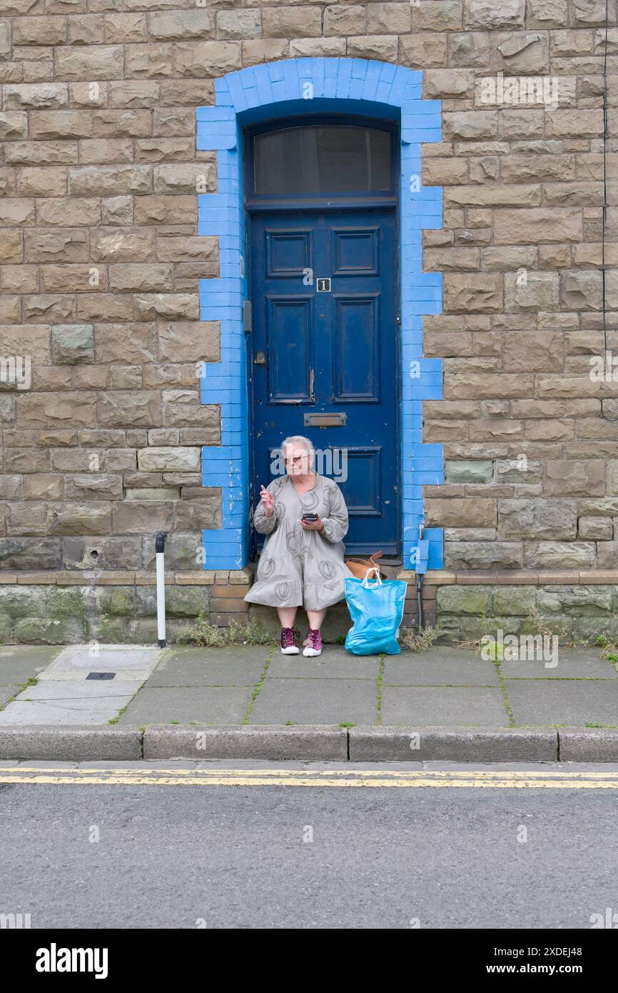 A tired,. middle aged woman with ash blonde hair, shopping and ...