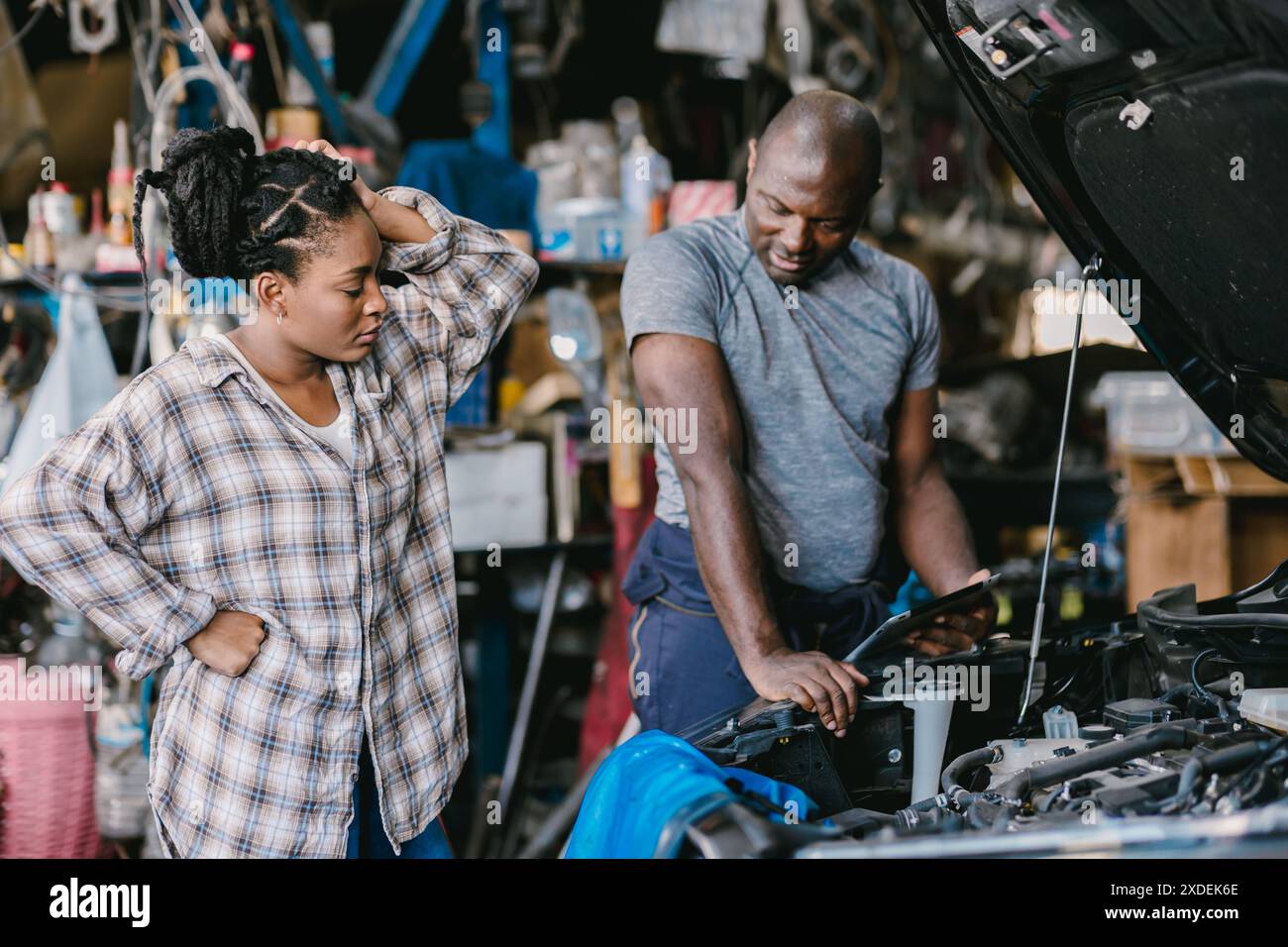 Mechanic man talking with stress worry customer inform explain car ...
