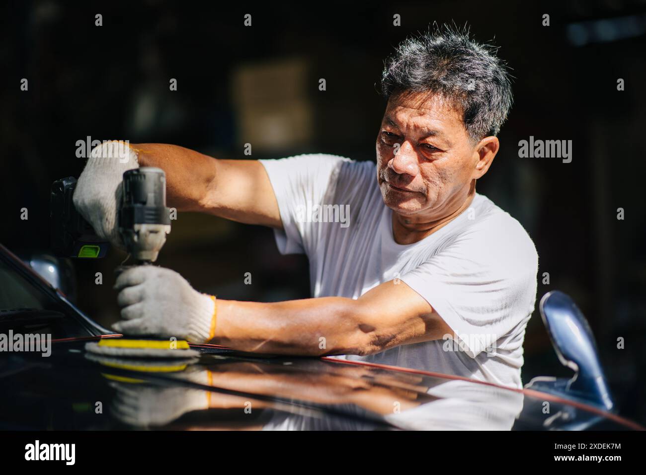 Car polishing, Worker in Auto workshop using color polisher machine ...