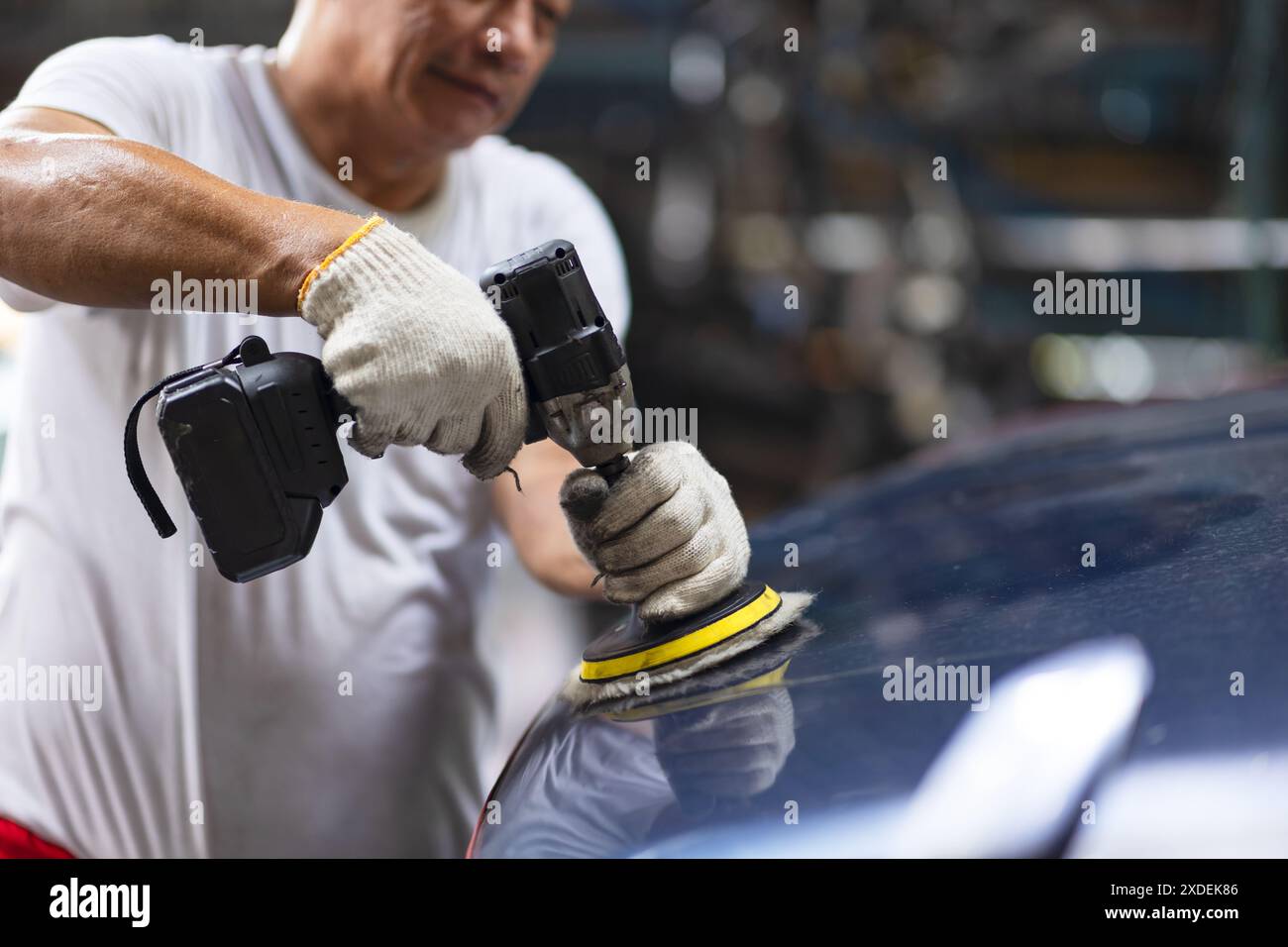 Car polishing, Worker in Auto workshop using color polisher machine ...