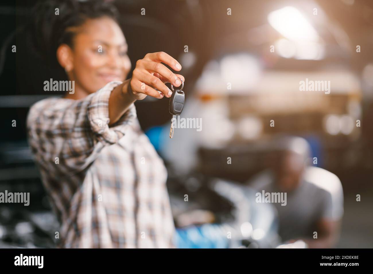 Happy African women showing Car Key smiling for return good healthy car ...