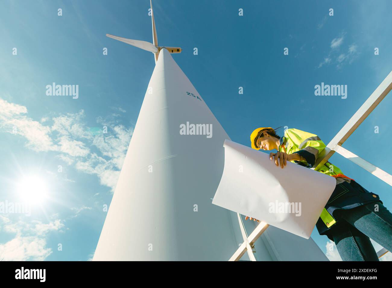 female engineer working outdoor with safety at wind turbines clean ...