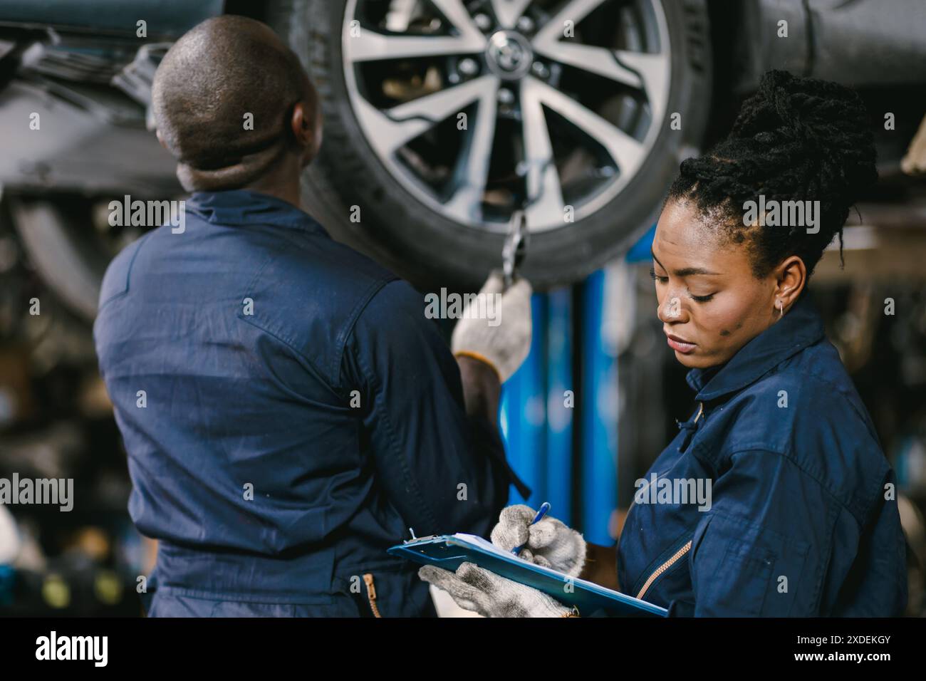 Mechanic Team Man and Women Staff Working Repair Vehicle in Car Service ...