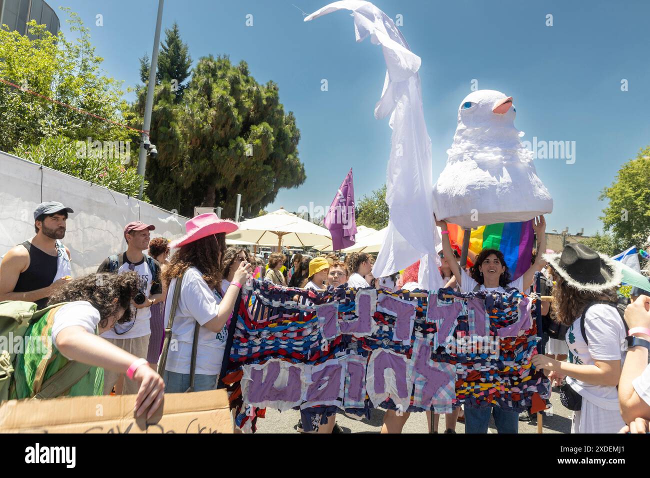 Haifa, Israel June 21, 2024, Pride. A girl holds a papier-mache dove ...