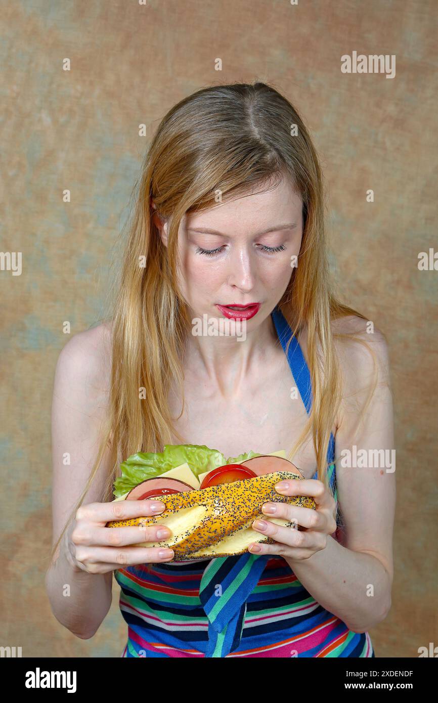 Beautiful woman holding sandwich in her hand to eat later Stock Photo ...