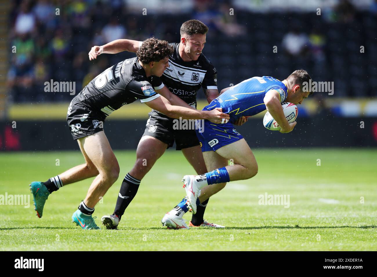 Warrington Wolves' Josh Thewlis is tackled by Hull FC's Lewis Martin (L ...