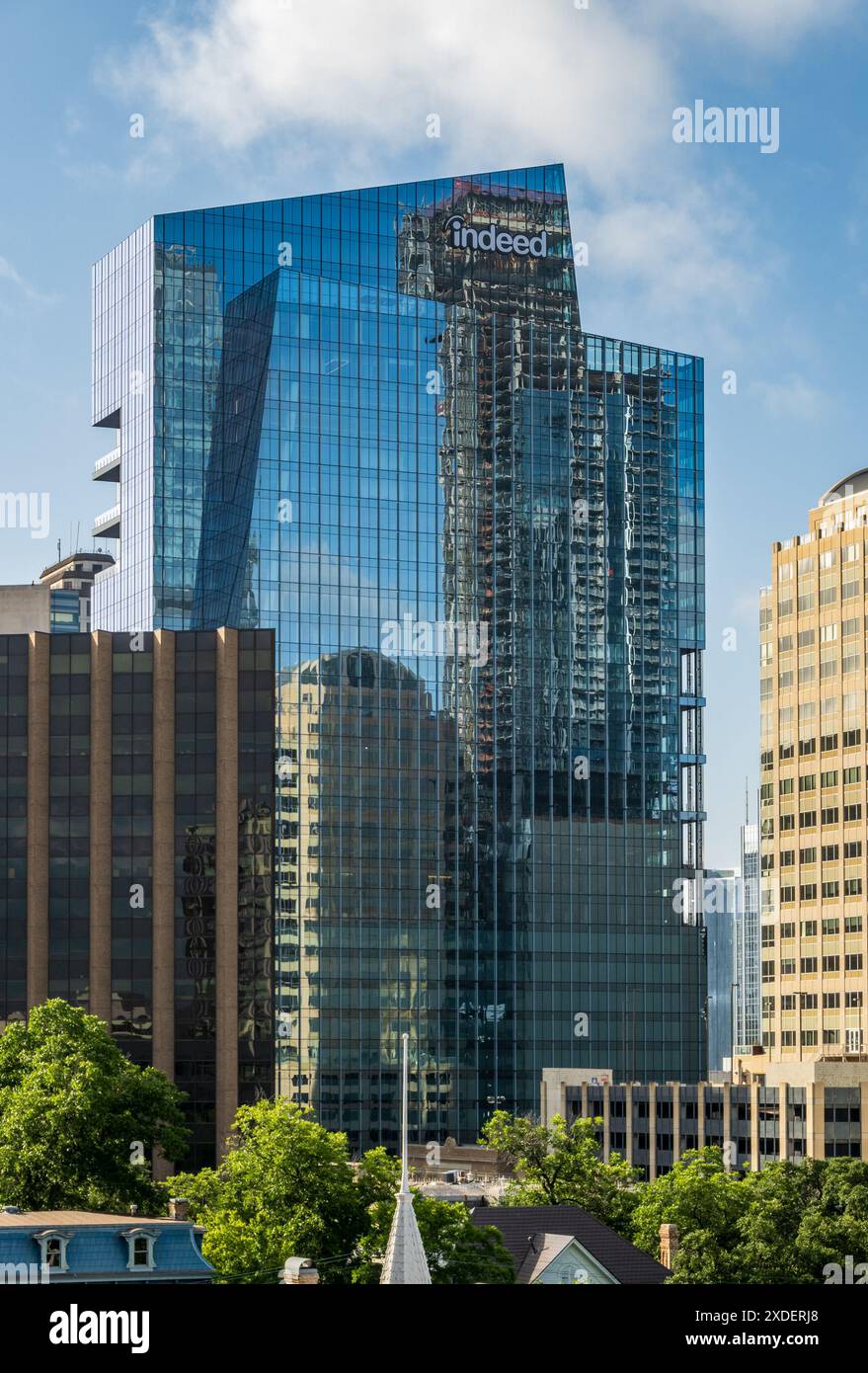 Austin, Texas - 15 June 2024: Indeed HQ skyscraper soars above older ...