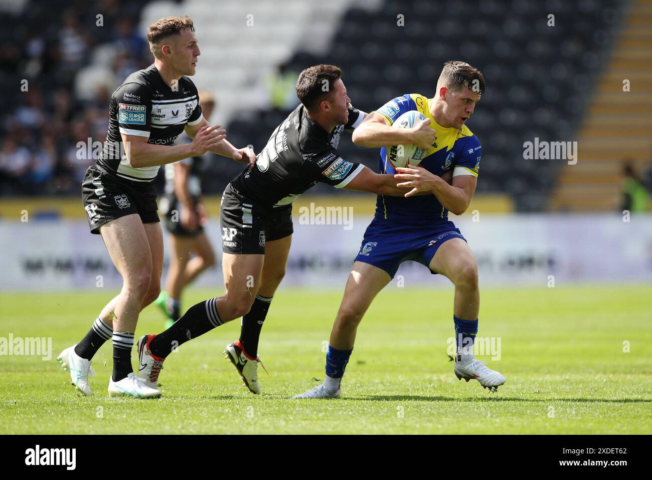 Warrington Wolves' Josh Thewlis is challenged by Hull FC's Jake Trueman ...