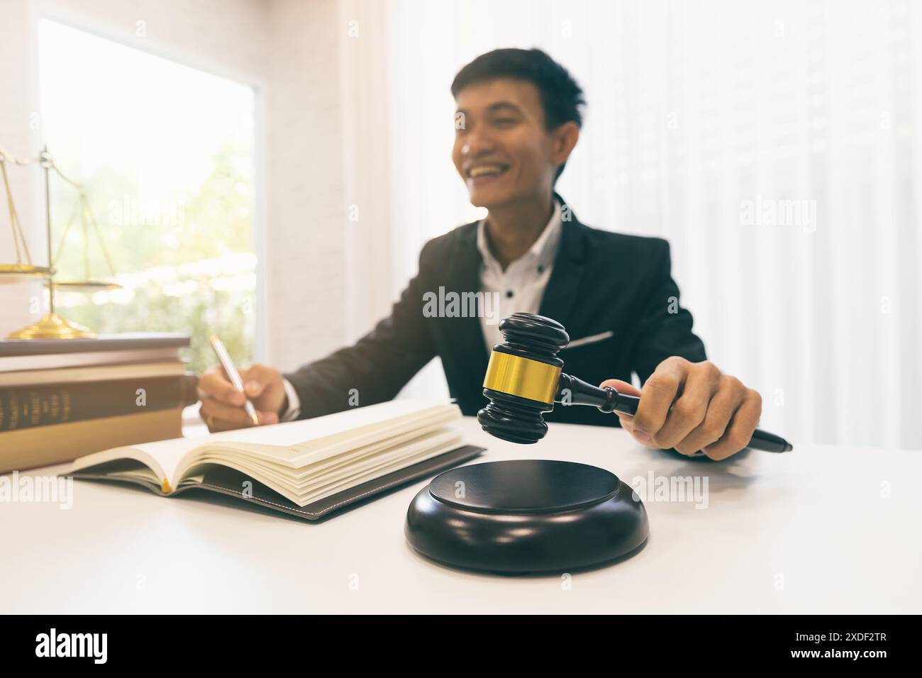Man judge holding gavel to bang on sounding block in the court room ...