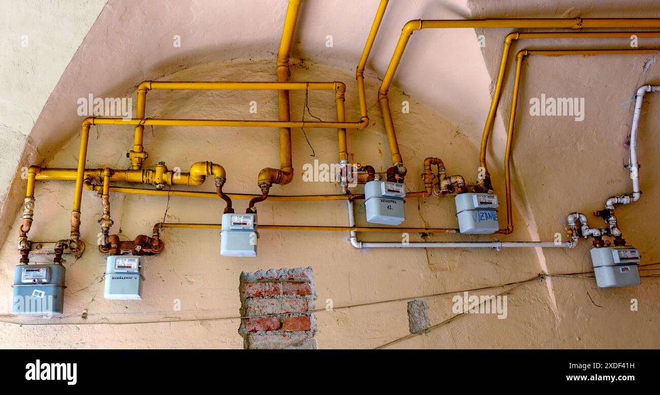 Extensive installation of yellow gas pipes and gas meters in an old residential building in ...