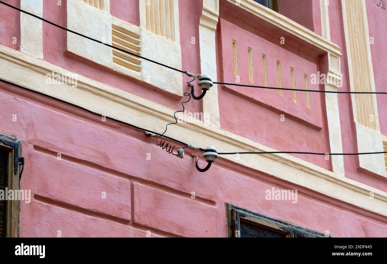 Old-fashioned power connection with overhead line at a traditional ...
