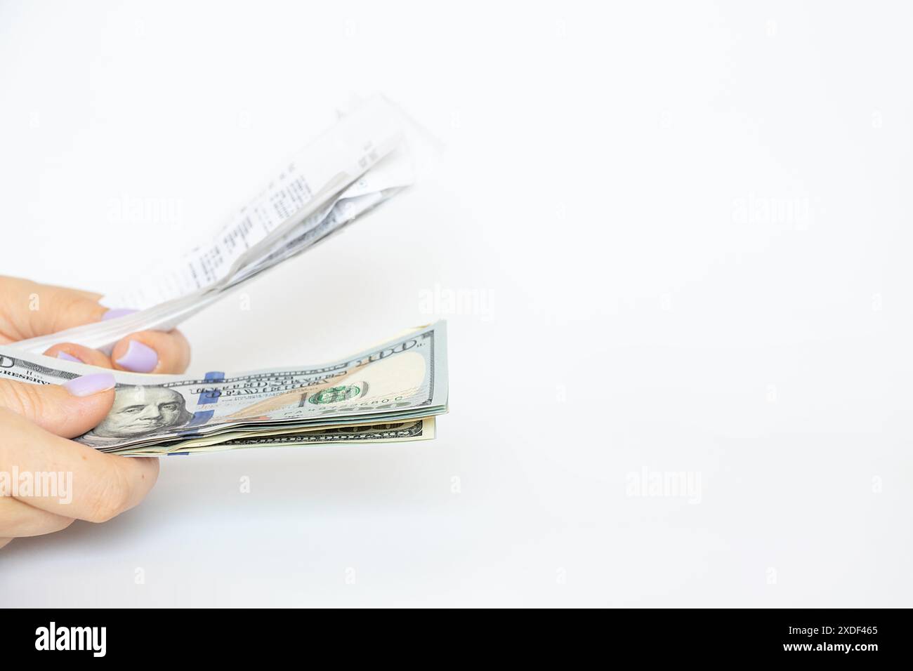 In the hands of a girl are receipts from a grocery store and dollars on ...