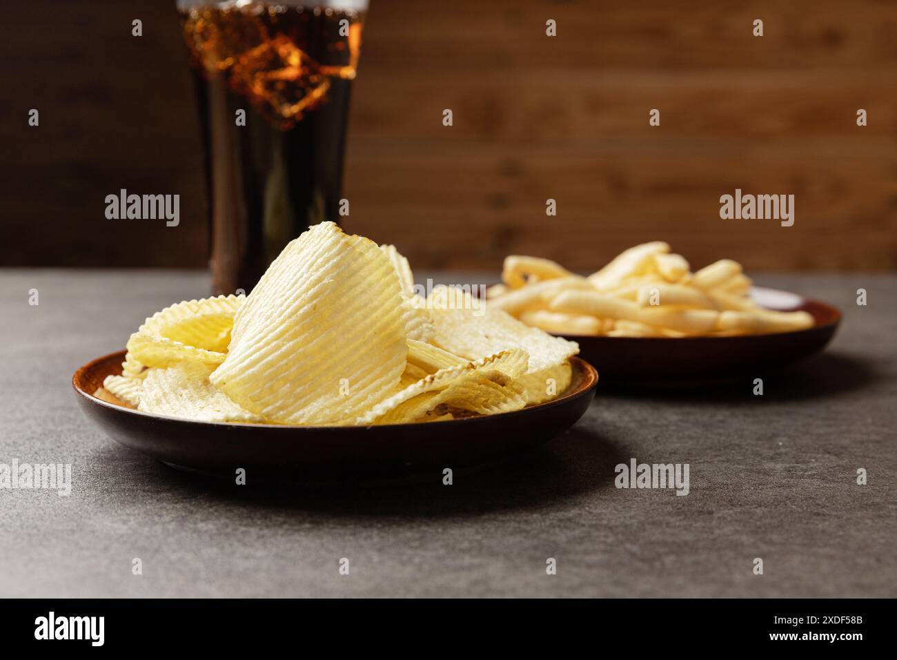 Potato chips, French fries snack and a glass of cola. Food and drink ...