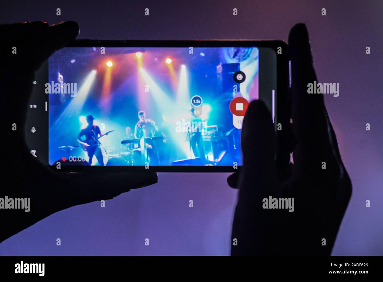 Recording of a concert with the cellphone from the audience Stock Photo ...