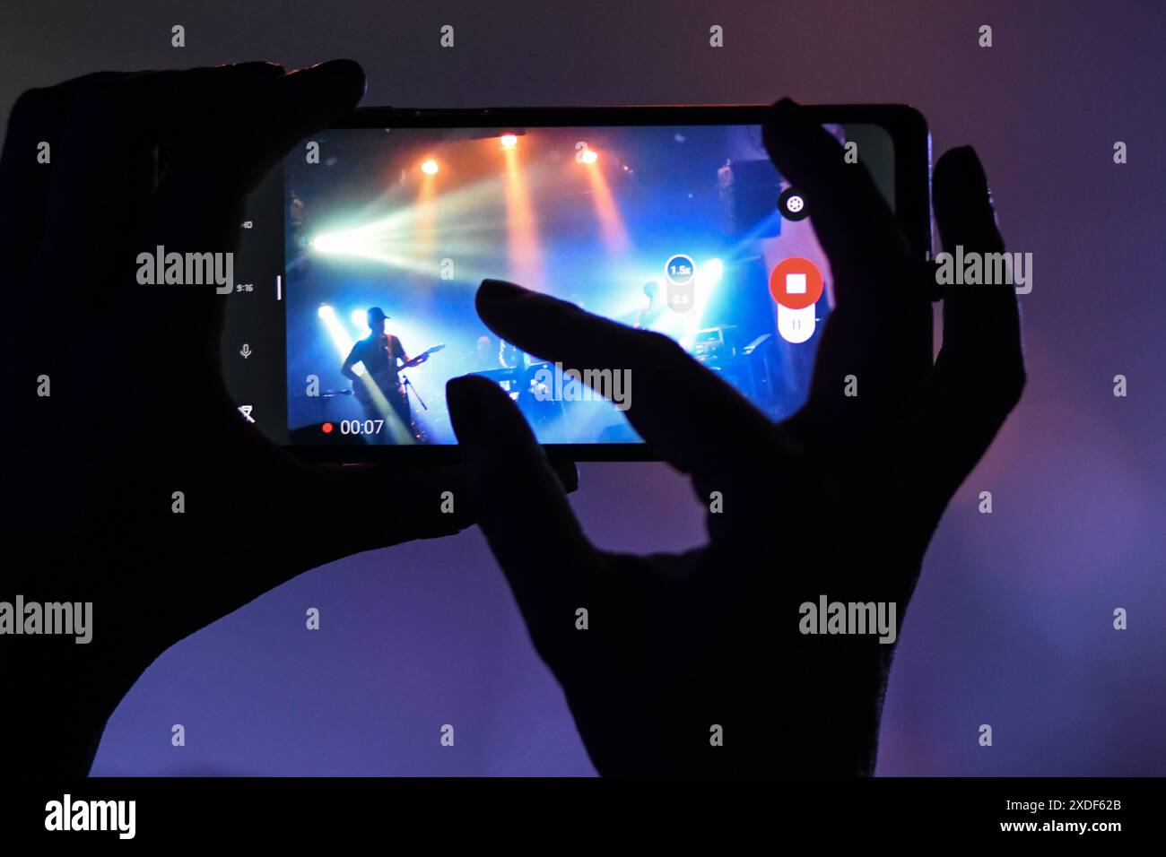 Recording of a concert with the cellphone from the audience Stock Photo ...