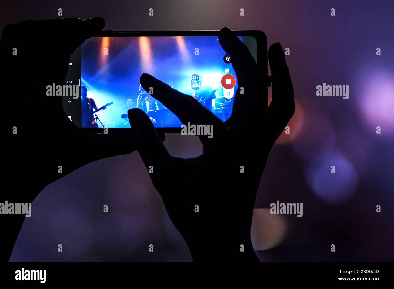 Recording of a concert with the cellphone from the audience Stock Photo ...