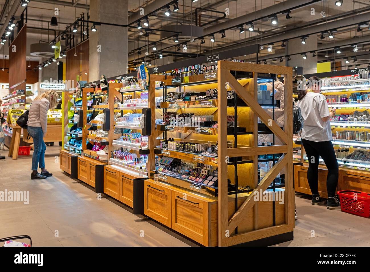 Interior of a cosmetics store. Customers test and select products for ...