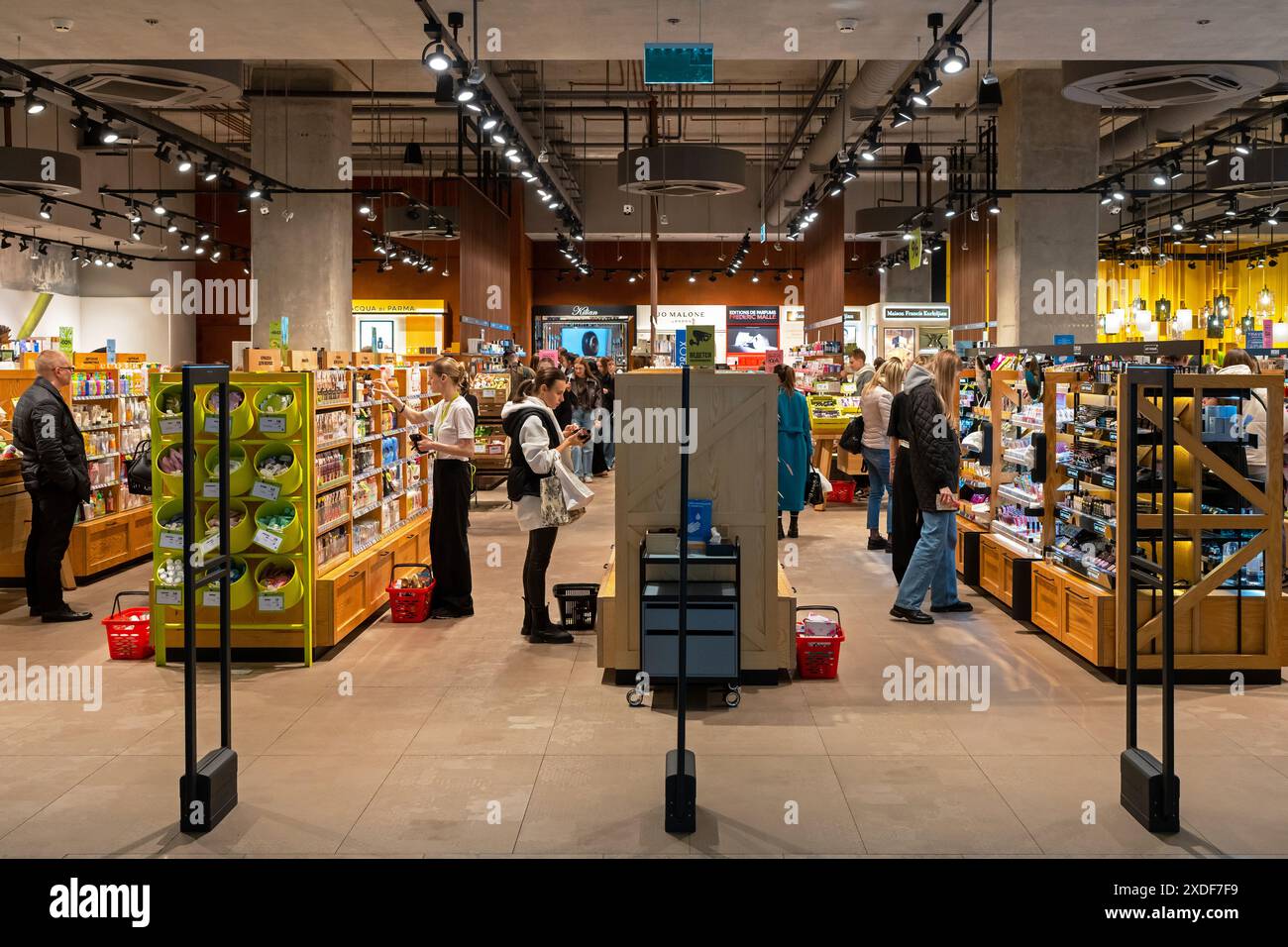 Interior of a cosmetics store. Customers test and select products for ...