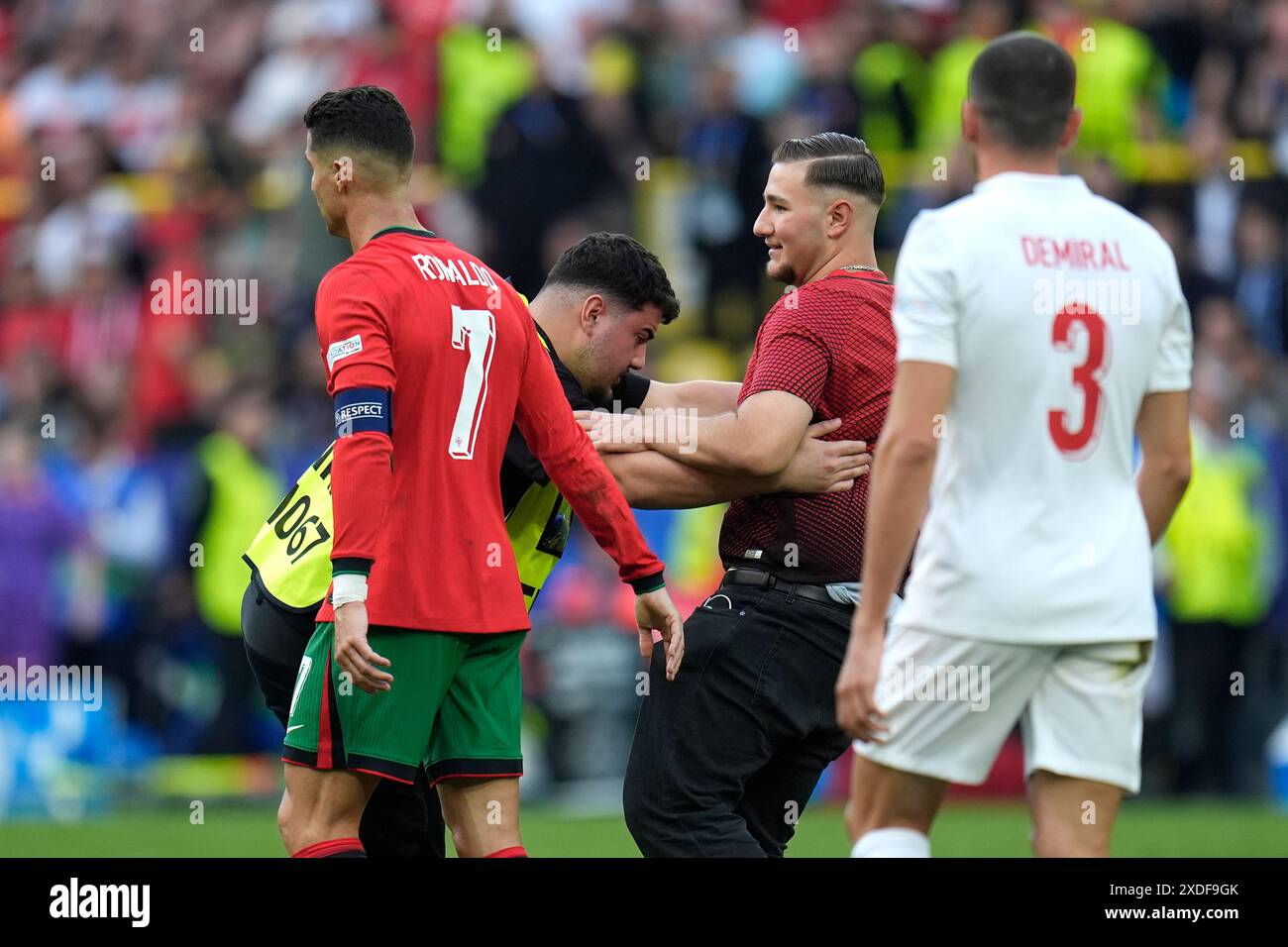 A third pitch invader attempts to get a photo with Portugal's Cristiano ...