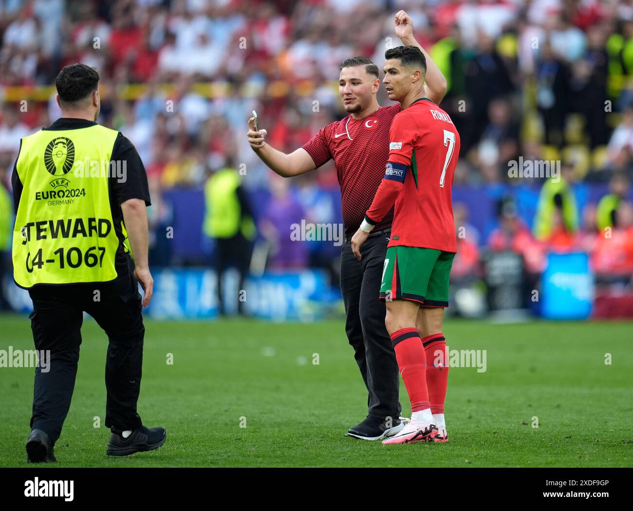 A third pitch invader attempts to get a photo with Portugal's Cristiano ...
