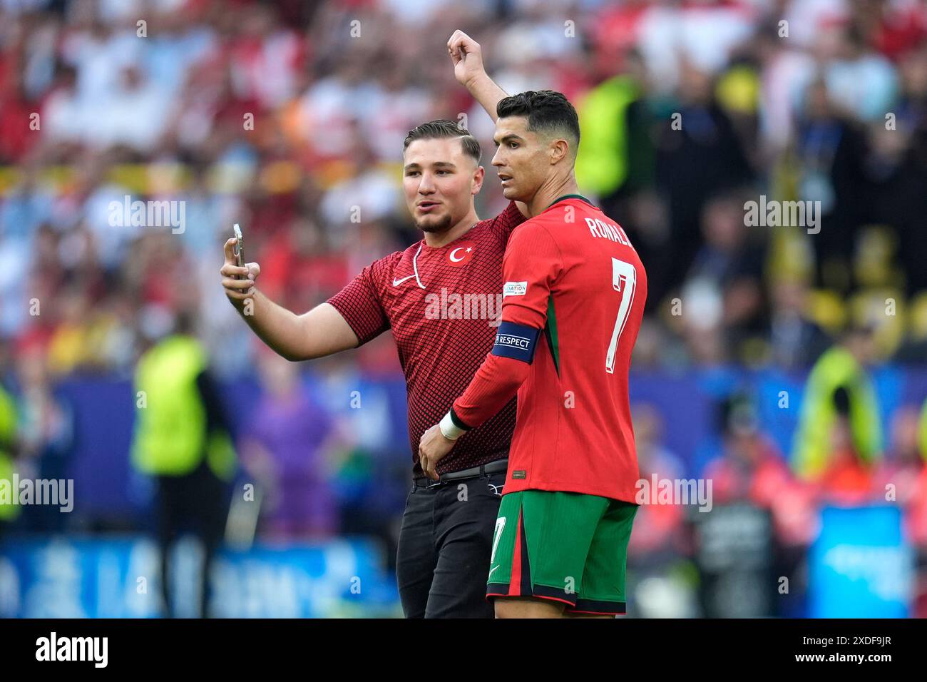 A third pitch invader attempts to get a photo with Portugal's Cristiano ...