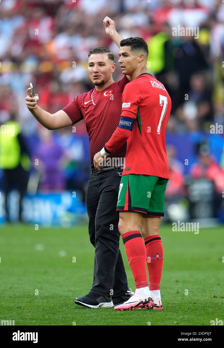 A third pitch invader attempts to get a photo with Portugal's Cristiano ...