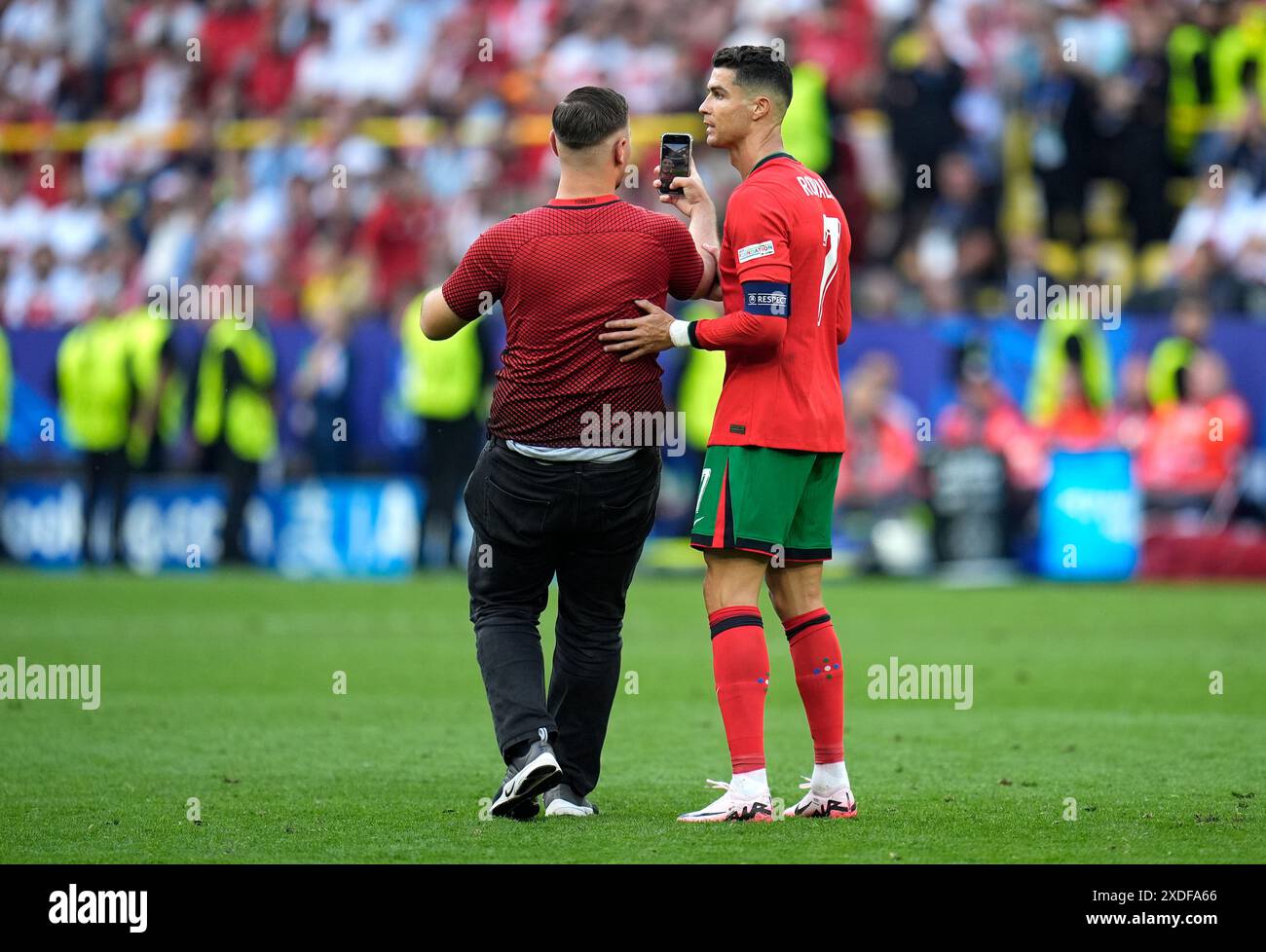 A third pitch invader attempts to get a photo with Portugal's Cristiano ...