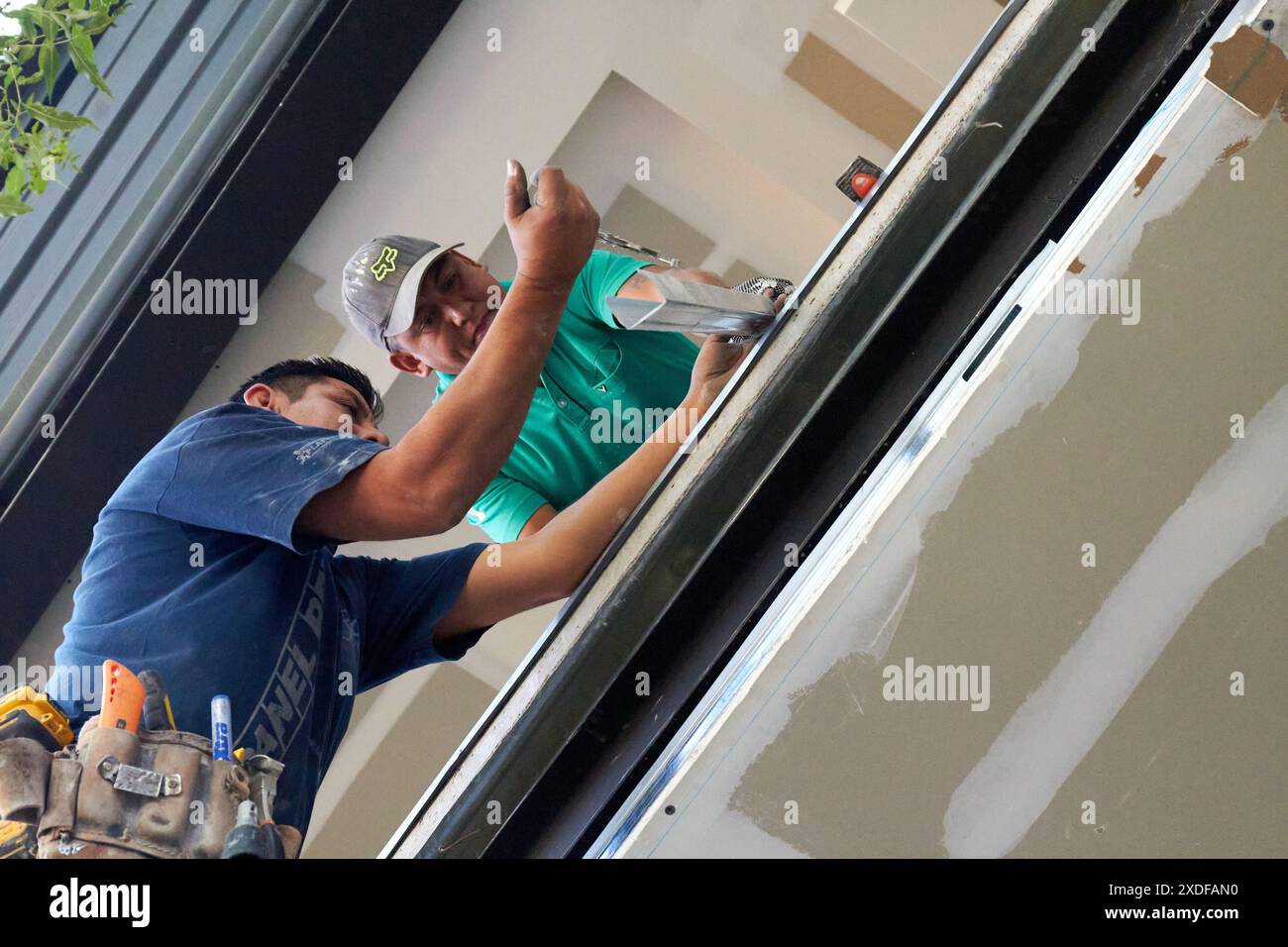 Mexican construction workers finishing interior house Stock Photo - Alamy