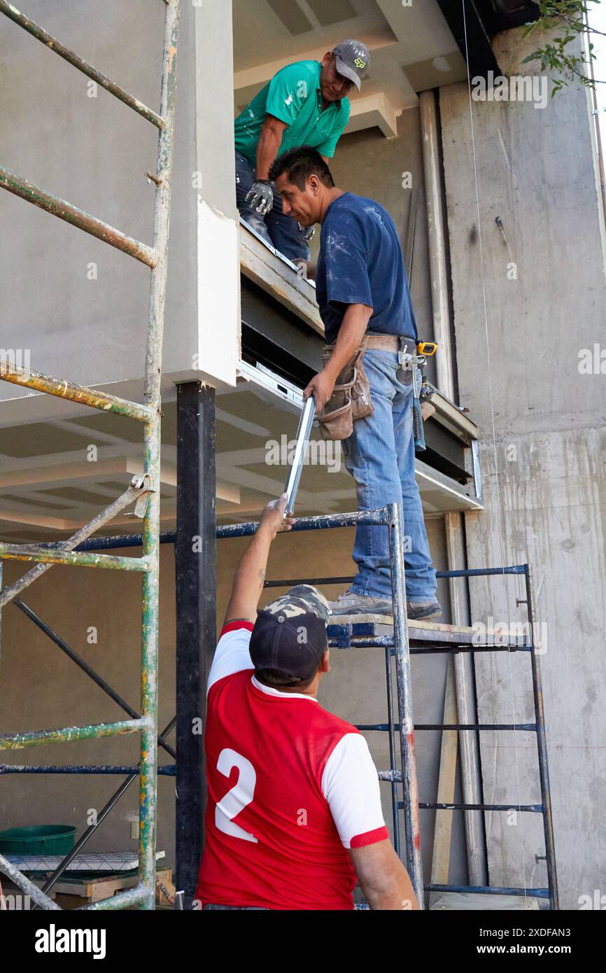 Mexican construction workers finishing interior house Stock Photo - Alamy