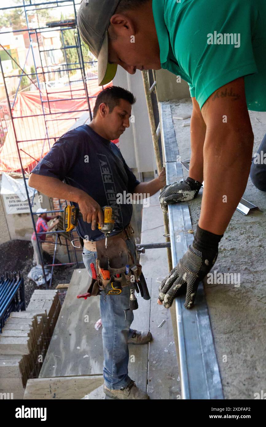 Mexican construction workers finishing interior house Stock Photo - Alamy