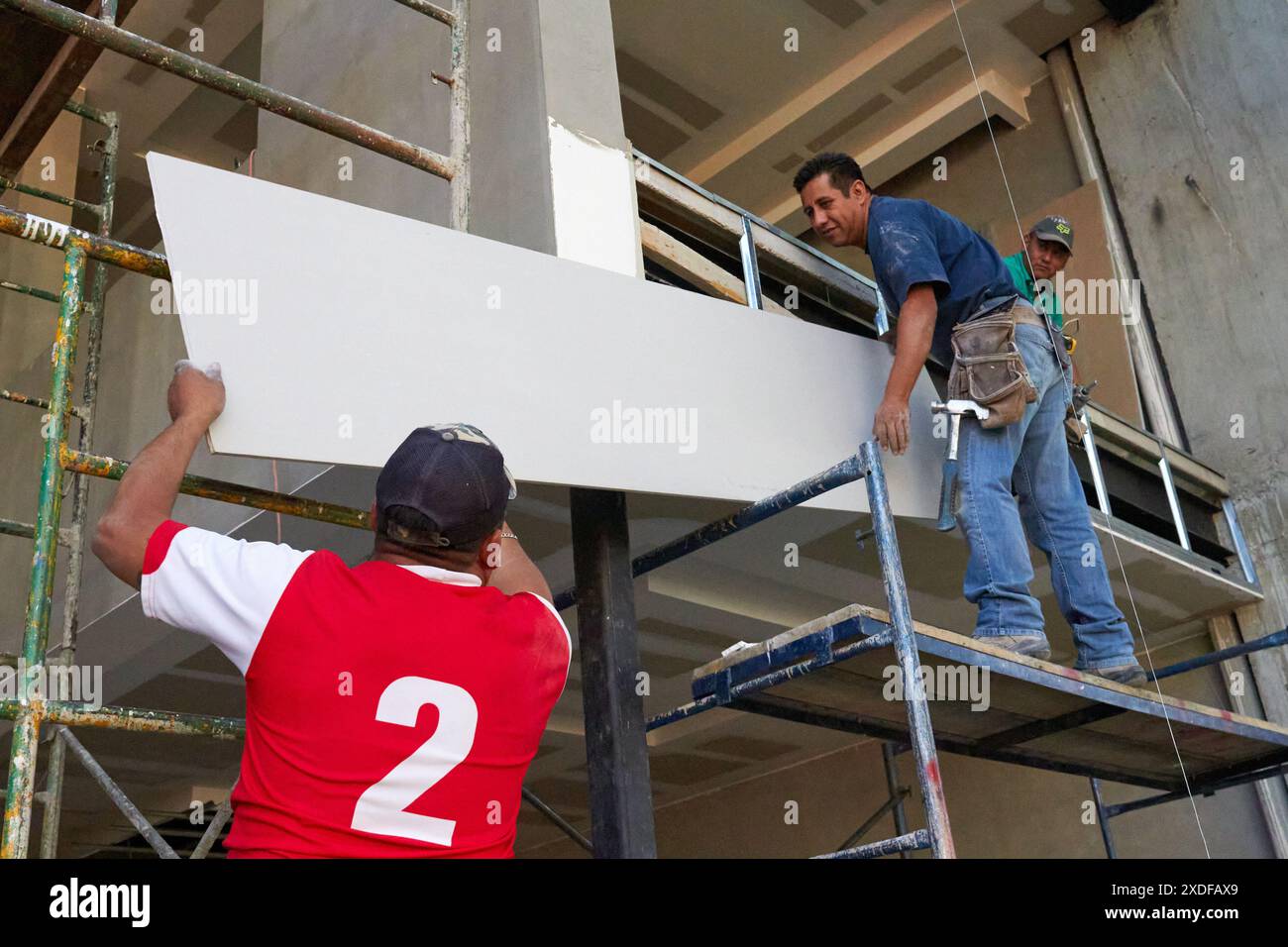 Mexican construction workers finishing interior house Stock Photo - Alamy