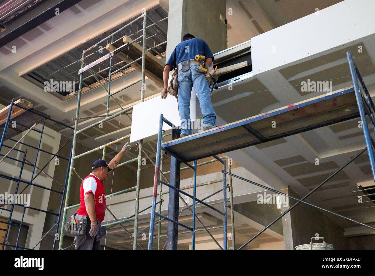 Mexican construction workers finishing interior house Stock Photo - Alamy