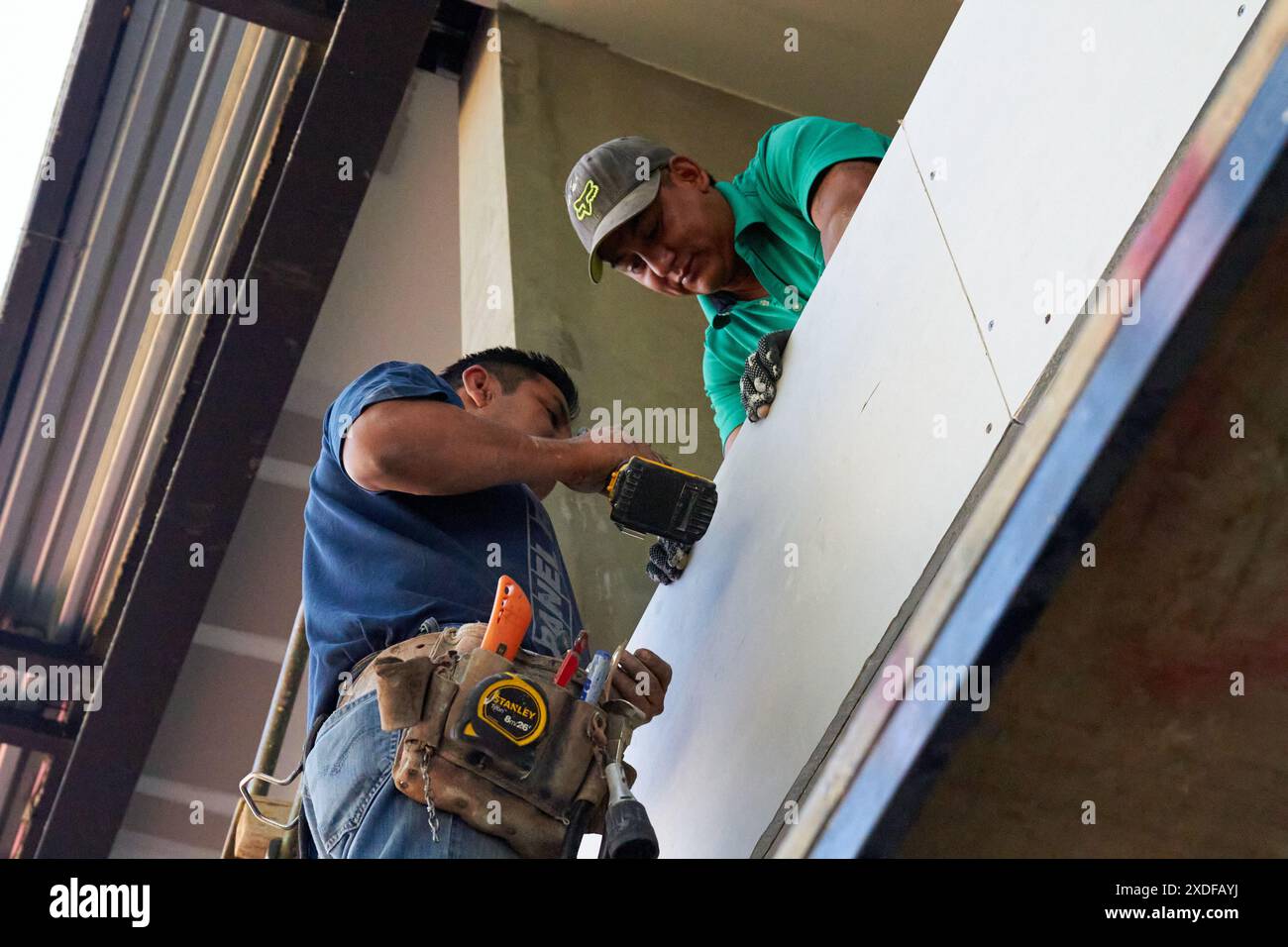 Mexican construction workers finishing interior house Stock Photo - Alamy