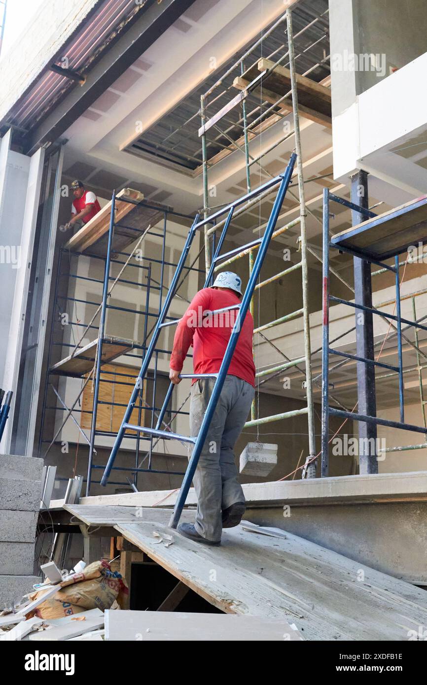 Mexican construction workers finishing interior house Stock Photo - Alamy