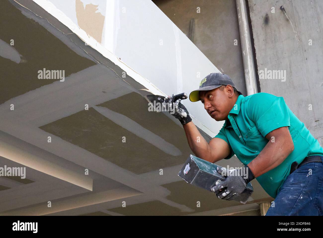 Mexican construction workers finishing interior house Stock Photo - Alamy